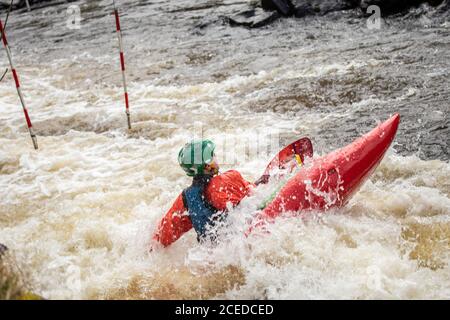 Guy in kayak sails mountain river. Whitewater kayaking, extreme sport ...