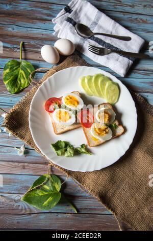boiled eggs with vegetables in black bowl Stock Photo - Alamy