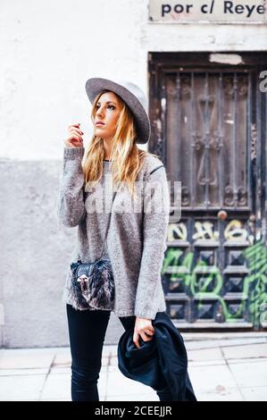 Young blonde woman wearing winter sweater over isolated background ...