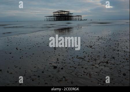 The silhouetted outline of Brighton's ruined burnt out West Pier ...