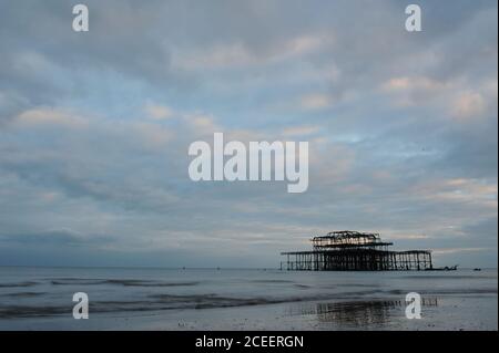 The silhouetted outline of Brighton's ruined burnt out West Pier ...