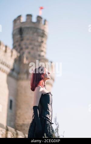 Pretty red haired medieval girl poses together castle Stock Photo - Alamy