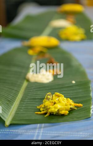 Traditional Kerala food being eaten on a banana leaf during the Onam ...