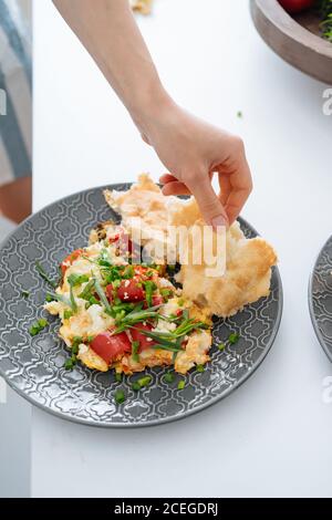 Unrecognizable woman serving of appetizing dish on table in restaurant ...