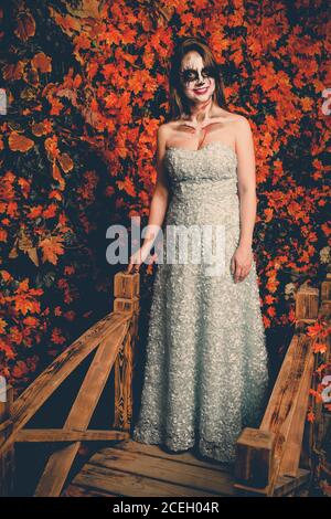 Portrait of a girl with a terrifying make-up on Halloween with pumpkin ...