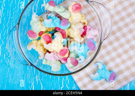 colorful neon gummy a cow candies on the black texture background Stock ...
