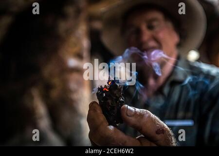 In an Aboriginal cave, the mosquitoes are driven away with the ...
