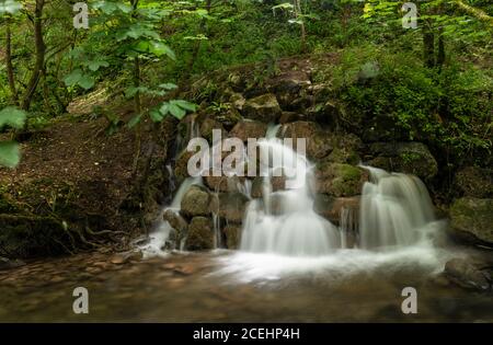 Waterfall at the Old Fussells Iron Works, Mells, Somerset, England, UK ...