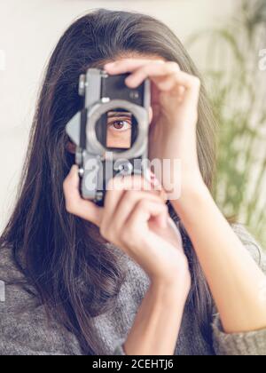Woman holding camera without lens Stock Photo - Alamy