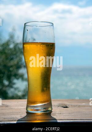 A steaming glass of beer stands on the bar Stock Photo - Alamy