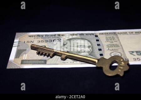 Indian rupee note with lock on white background Stock Photo - Alamy