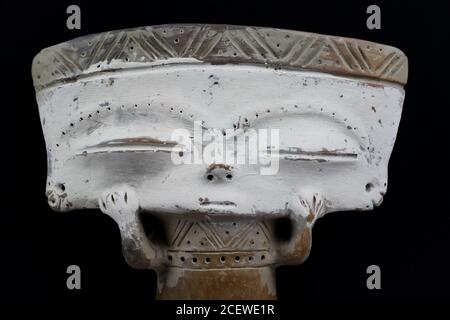 Closeup of isolated abstract inca clay figure with rectangular head and ...