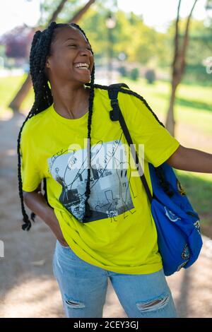 Young african american woman over grey grunge wall wearing orange ...
