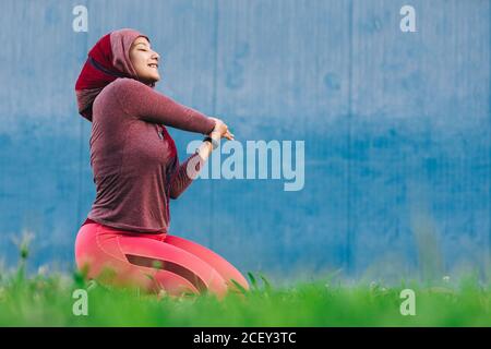 Muslim Woman Athlete Stretching on Running Track in Hijab at Outdoor ...