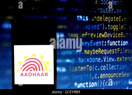 In this photo illustration an Aadhar company Logo seen displayed on a ...
