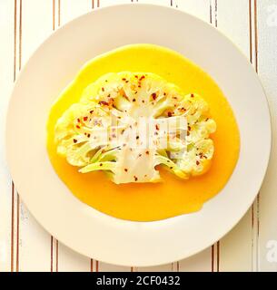Cooking of cauliflower steak, Vegetarian cuisine. Gray background. Top ...