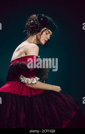 Love tragic. Young woman as Anna Karenina isolated on dark blue ...