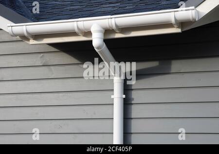 Rain Gutter System and Bitumen Roof Shingles Stock Photo - Alamy