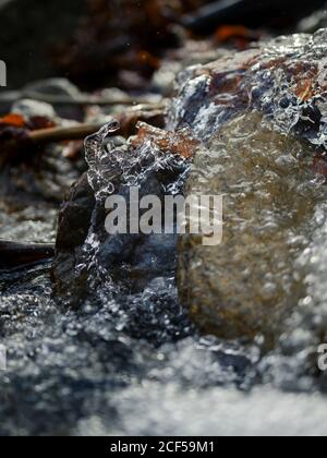 Closeup of rough river water surface with water splashes in neo mint ...