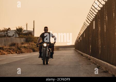 Strong man driving motorcycle Stock Photo - Alamy
