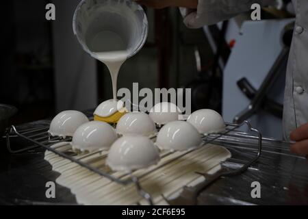 Unrecognizable person decorating pastry and pouring apples in caramel ...