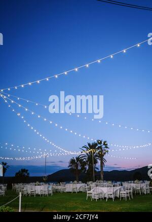 Festive hanging garlands with glowing light bulbs against the ...