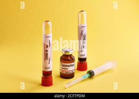 Test tubes with blood samples near cotton swabs on blue background ...