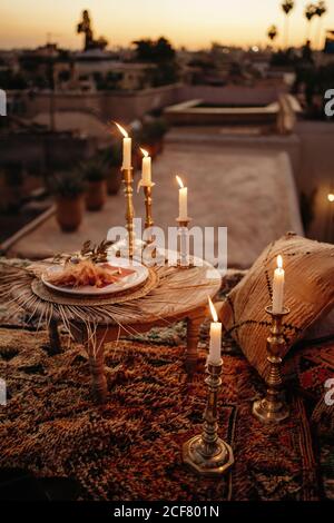 Cozy home composition with burning candles on a blurred background ...