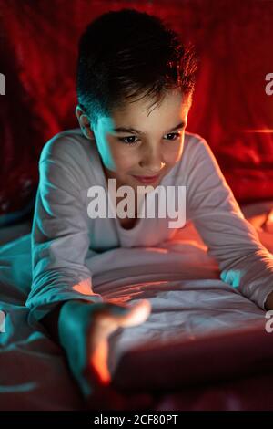 Delighted boy watching cartoon on tablet Stock Photo - Alamy