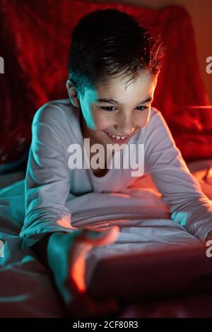 Delighted boy watching cartoon on tablet Stock Photo - Alamy