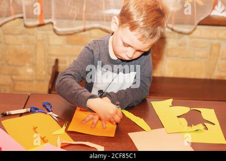 Child trace around a hand on paper with crayons. A simple drawing of a ...