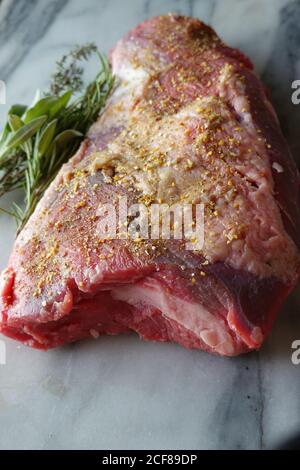 Seasoned raw tri-tip beef meat steak on plate. Isolated on white ...