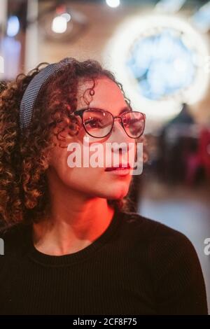 Beautiful lady in glasses thinking while looking up Stock Photo - Alamy