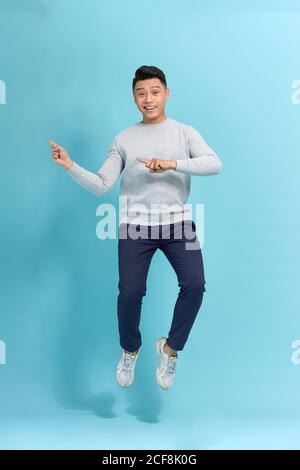 Young handsome man pointing fingers to camera with happy and funny face ...