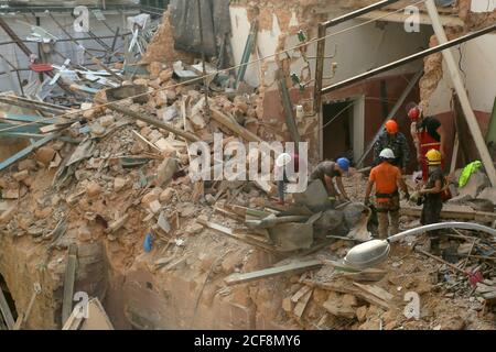 Rescue workers search the rubble after a London office block was hit ...