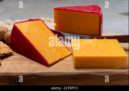 Aged cheddar cheese with red wax coating, a dried fig, organic, red wax ...