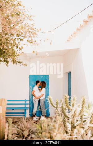 Loving couple cuddling near beach house Stock Photo - Alamy