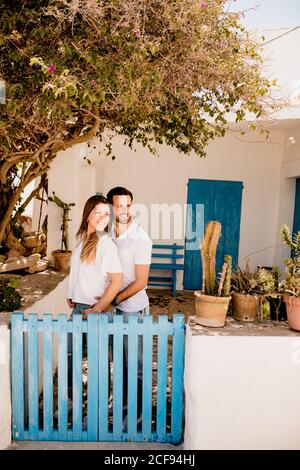 Loving couple cuddling near beach house Stock Photo - Alamy