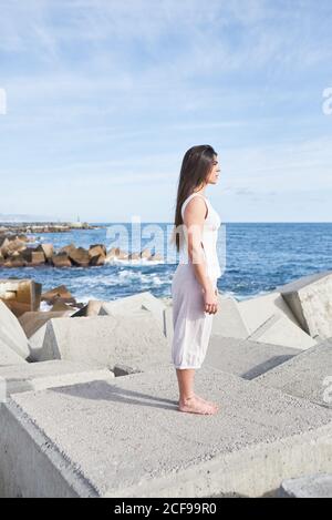 Side view full body of young female athlete in activewear with ponytail ...