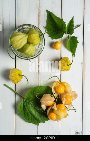Physalis peruviana fruit on wooden table closeup Stock Photo - Alamy