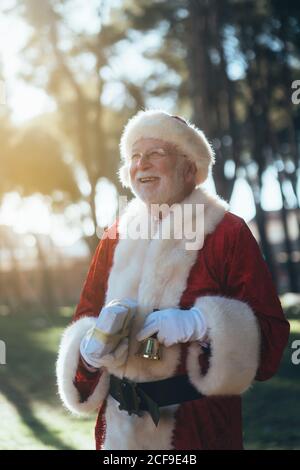 Bearded santa claus in costume covering face isolated on grey,stock ...
