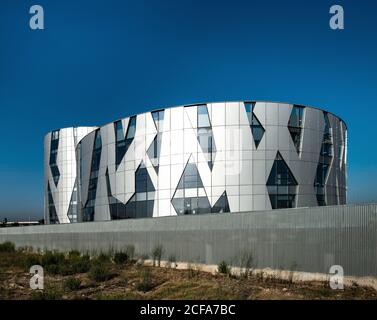 Geometric facade of spherical buildings with blue windows against clear ...