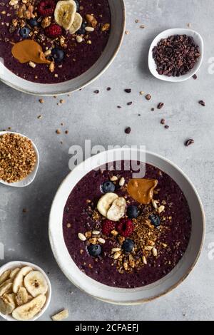 Composition with tasty acai smoothie bowls on table Stock Photo - Alamy