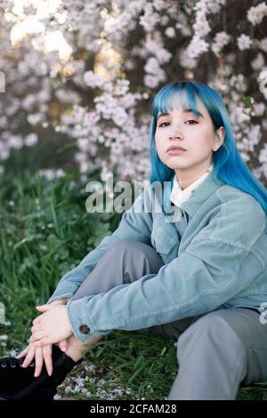 Sad hipster woman sitting on the pier with sadness Stock Photo - Alamy