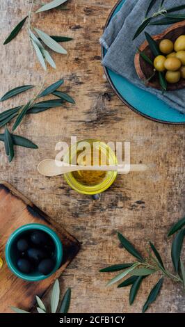 Olives, olive branch ,Olive oil on wooden background Stock Photo - Alamy