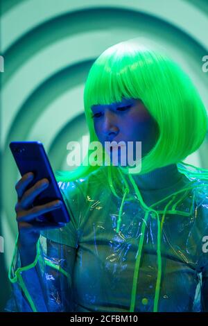 Asian young woman using smartphone voice assistant making hands free ...
