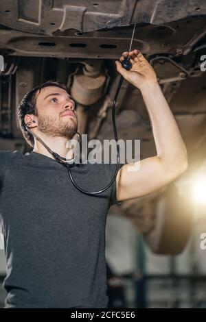 mechanic listen engine with stethoscope in repair garage Stock Photo ...