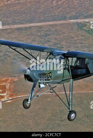 A Fieseler Fi 156 Stork airplane flies over the crowd of people on ...