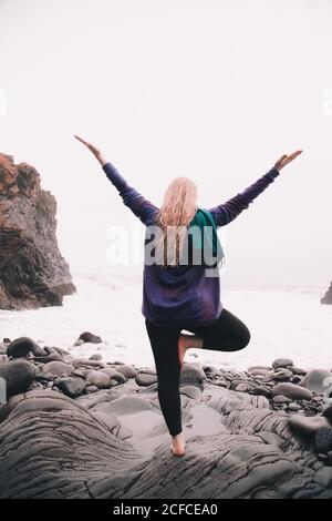 Woman meditating near sea, back view. Scheme of seven chakras ...