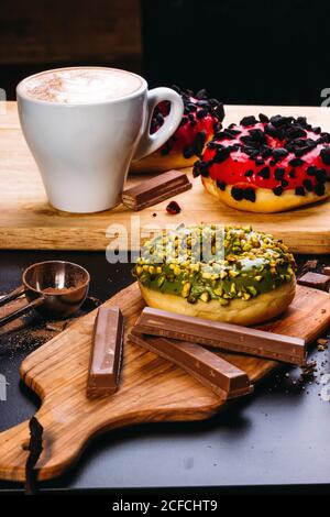 Assorted doughnuts in the glaze, colorful sprinkles and nuts on a white ...